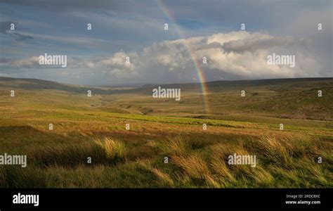 Rainbow Over The North Pennines Fields Lit By Transient Light Stock