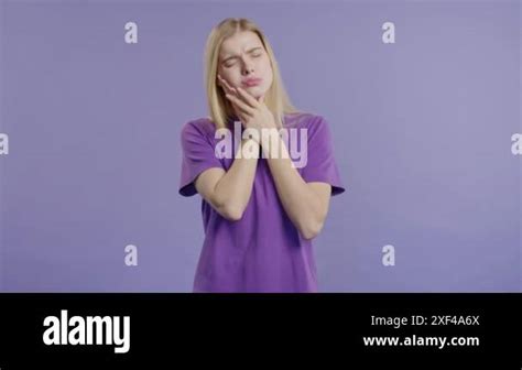 Pretty Young Girl With Tooth Pain On Violet Studio Background