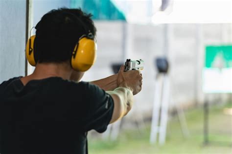 Premium Photo Asian Shooter Man Wearing Noise Canceling Headphones