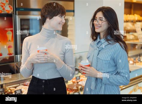 Pretty Blonde Girl Choosing Dessert From Glass Showcase In Bakery Shop
