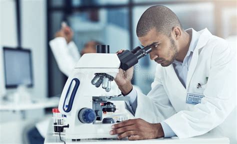Man Microscope And Science At Lab For Test Assessment And Blood