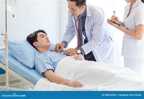 Asian Professional Male Doctor In White Lab Coat Using Stethoscope Listening Monitoring