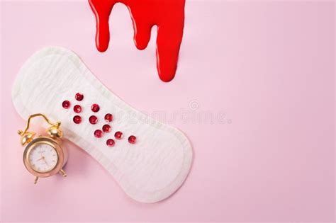 Blood Alarm Clock And Feminine Hygiene Pad With Red Glitter On Pink Background First Menstrual
