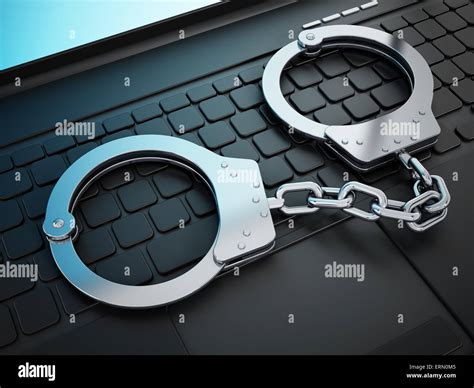 Internet Crime Concept With Handcuffs Standing On Laptop Keyboard Stock