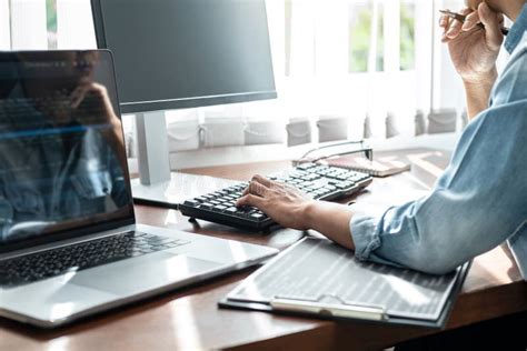 Asian Woman Programmer Looking Code Data On Screen Laptop And Thinking