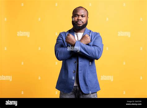 Assertive African American Man Showing Letter X With Arms Crossed