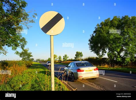 Cars Passing Derestricted Roadside Speed Limit Warning Sign United