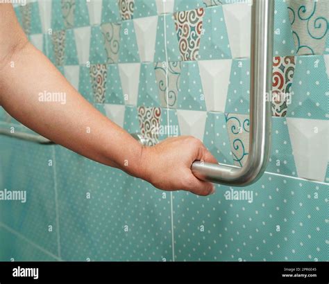 Asian Woman Patient Use Toilet Support Rail In Bathroom Handrail