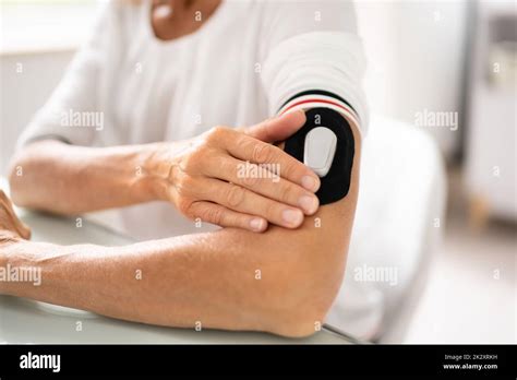 Woman Testing Glucose Level With A Continuous Glucose Monitor Stock Photo Alamy