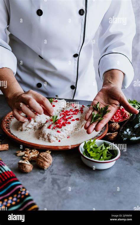 Mexican Woman Chef Cooking Chiles En Nogada Recipe With Poblano Chili