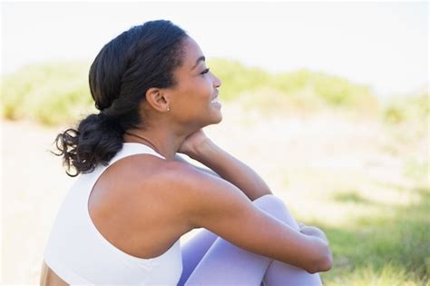 Premium Photo Fit Woman Sitting On Grass Smiling