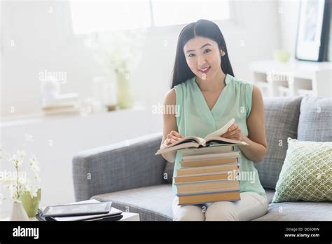 Woman With Stack Of Books At Home Stock Photo Alamy