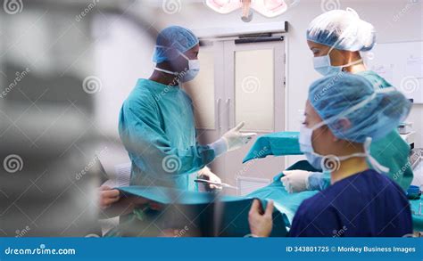 Surgical Team Performing Surgery In Modern Operation Theaterteam Of