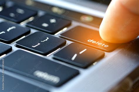 Finger Of The Computer User He Presses The Delete Button On The Computer Keyboard Stock Photo