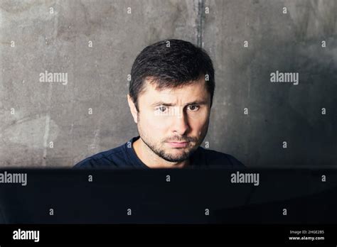 handsome serious bearded man sitting at the office desk working and