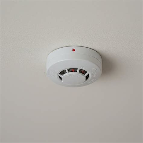 Ceiling Mounted Smoke Detector With A Round White Plastic Housing Features A Small Stock