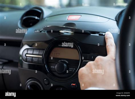The Man Pressing Eject Button On Cd Player To Eject The Cd Car Audio