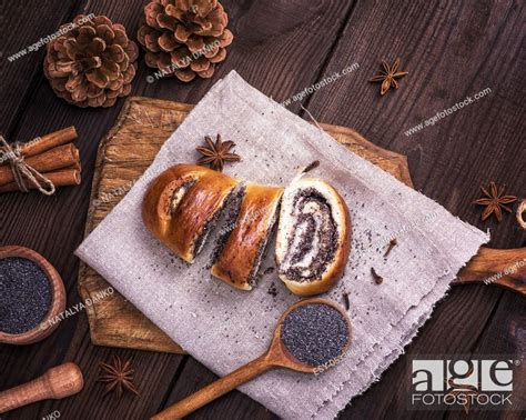 Sliced Poppy Rolls On A Gray Linen Napkin And Poppy Seeds In A Wooden