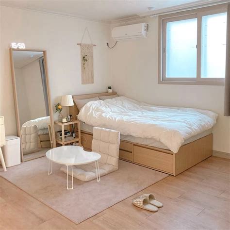 A Bedroom With A Bed Table And Mirror