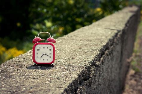 Premium Photo Red Vintage Style Analog Alarm Clock On A Concrete Surface