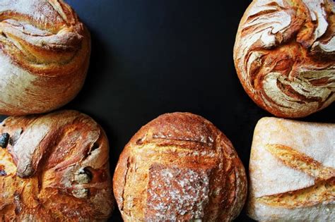 Premium Photo Bread Assortment Of Different Types Of Bread On A Black