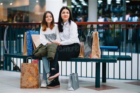 Beautiful Young Mom And Teenage Daughter Are Holding Shopping Bags
