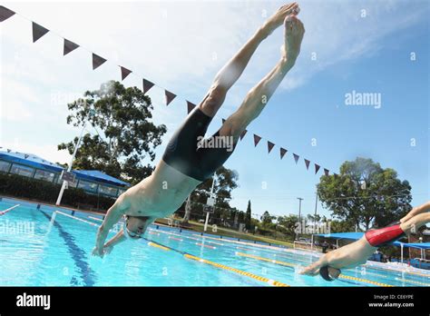 Swimmers Diving Into Pool Stock Photo Alamy