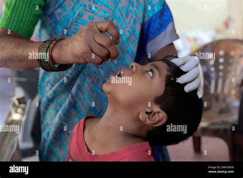 An Indian Medical Volunteer Administers A Dose Of Polio Vaccine To A