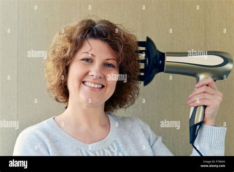 Woman Doing Curls With Hairdryer And Diffuser Stock Photo Alamy