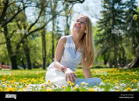Smiling Happy Young Terson Teen Girl Sitting Outdoors Looking Away