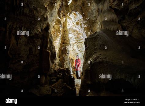Speleologist In A Cave Column Stalagmites And Stalactites Stalagnate