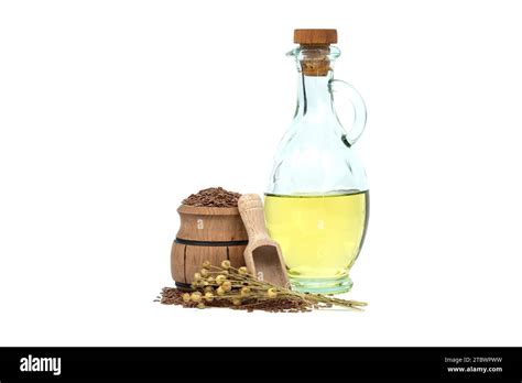 Linseed Oil In Glass Decanter And Flax Seeds In Wooden Scoop And Bunch