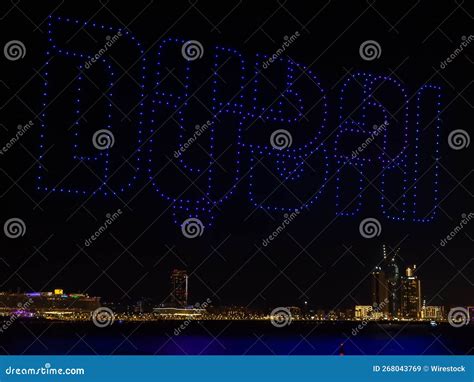 Illuminated Glowing Blue Drones Forming The Name DUBAI Text In The