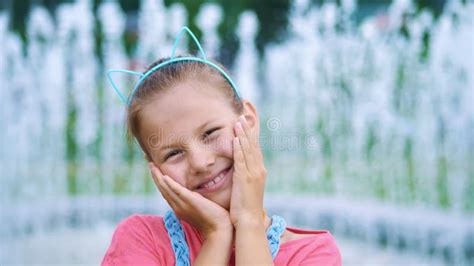 Smiling Happy Eight Year Old Girl In Swimsuit Having Fun In Splashes