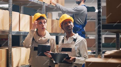 Multiethnic Team Of Supervisors Counting Boxes Of Goods Placed On