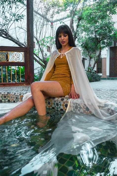 Beautiful Moroccan Girl In Short Golden Dress And White Mantle Cloak In