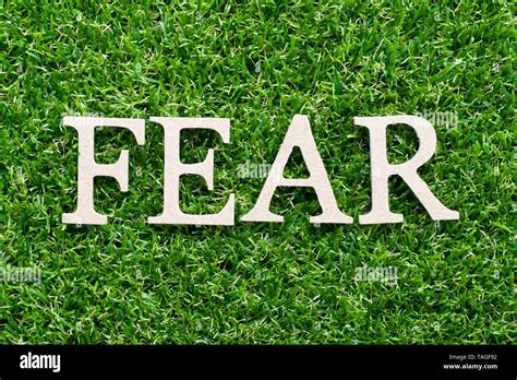 Wood Alphabet In Word Fear On Artificial Green Grass Background Stock