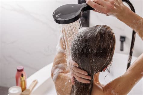 Woman Washing Her Hair While Taking Shower At Home Back View Hair