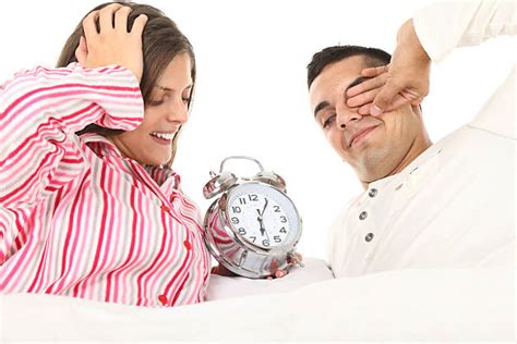Attractive Woman Waking Up In Morning With Her Husband Sleeping Stock