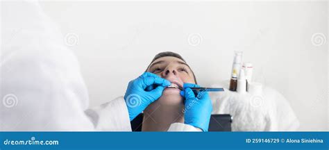 Installation Of Braces Bridges And A Dental Plate To Correct Teeth An Orthodontist Installs A