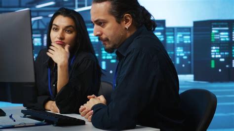 It Technicians In Server Farm Brainstorming Ways To Repair Equipment