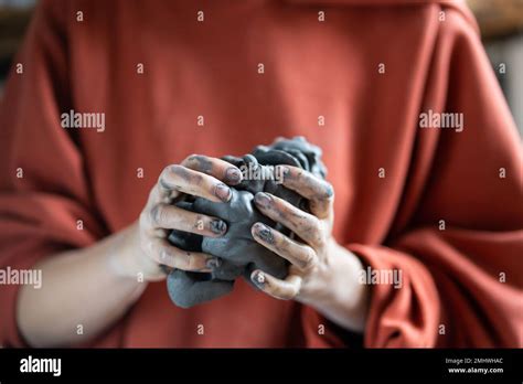 Woman Holding Piece Of Clay While Visiting Pottery Master Class