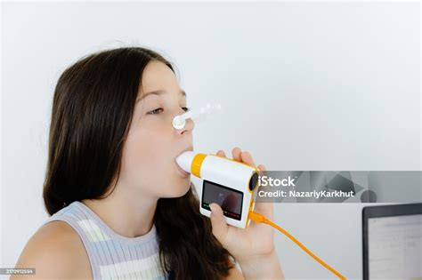 Girl Testing Breathing Function By Spirometry In Doctors Office Diagnosis Of Respiratory