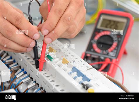 Electrician Testing An Electric Smart Panel Fuse Box Using A Multimeter Tester Stock Photo Alamy