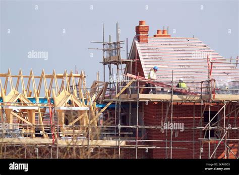Construction Workers Builders On Scaffolding Erecting A New Build Home