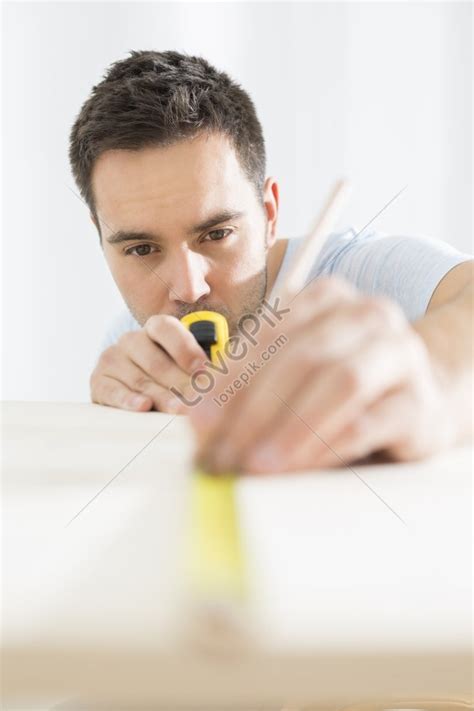 Mid Adult Man Measuring Table With Tape Measure Photo Picture And Hd