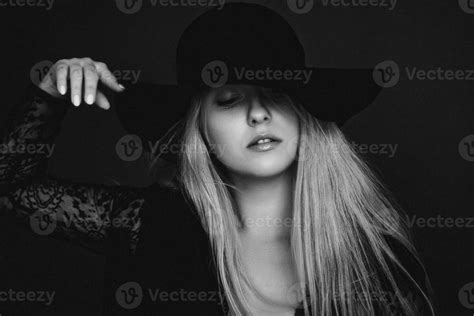 Beautiful Blonde Woman Wearing A Hat Artistic Film Portrait In Black