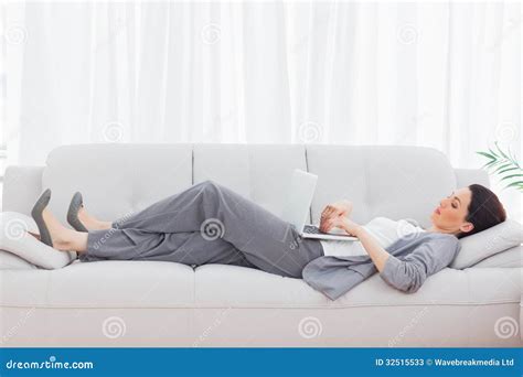 Businesswoman Using Her Laptop Lying On Sofa Stock Image Image Of