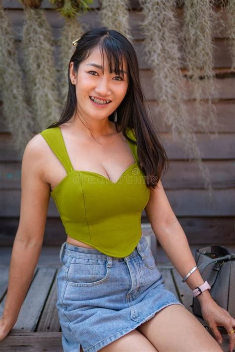 Portrait Of Beautiful Asian Woman Wearing A Green Strapless Dress And