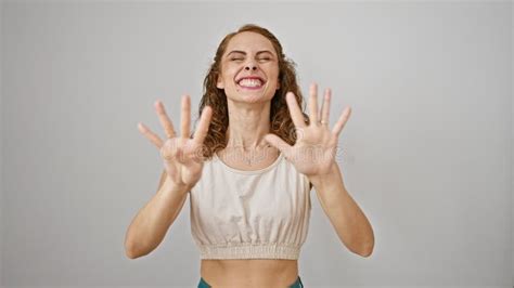Confident Young Woman Cheerfully Pointing Up With Number Nine Finger